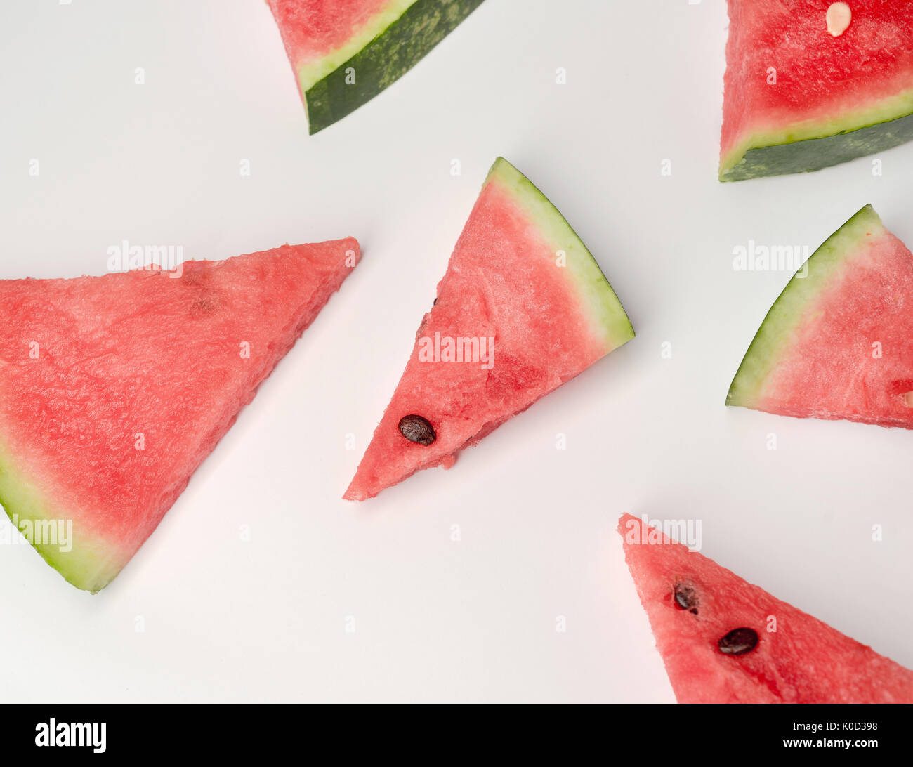 Different triangle pieces of red ripe watermelon on white background ...