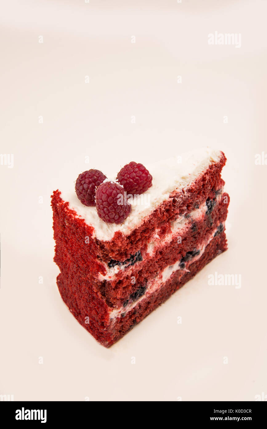 Side view of red pie with raspberries and white cream isolated over ...