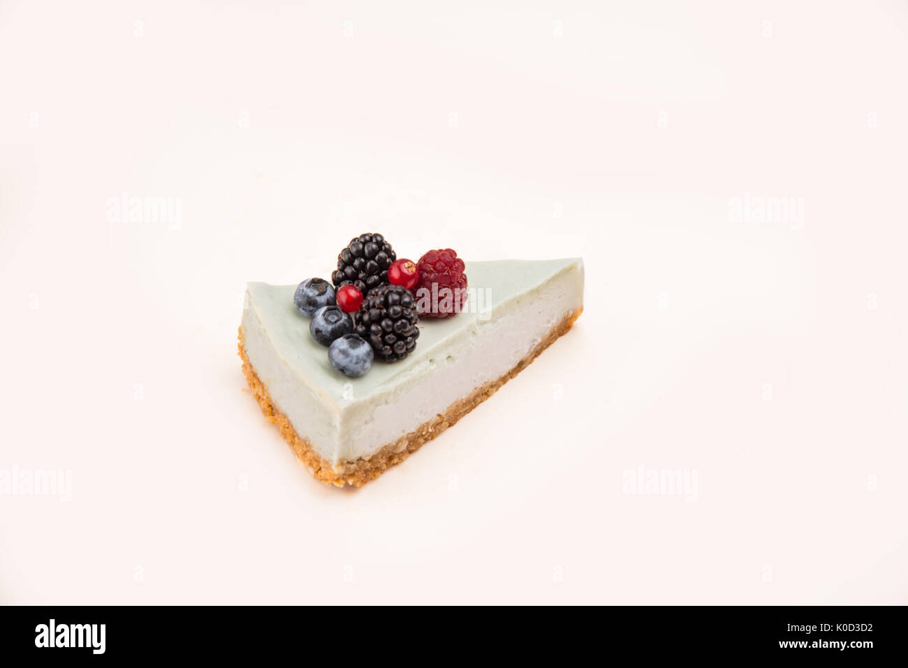 Side view of blue cheesecake with different berries on it isolated over ...