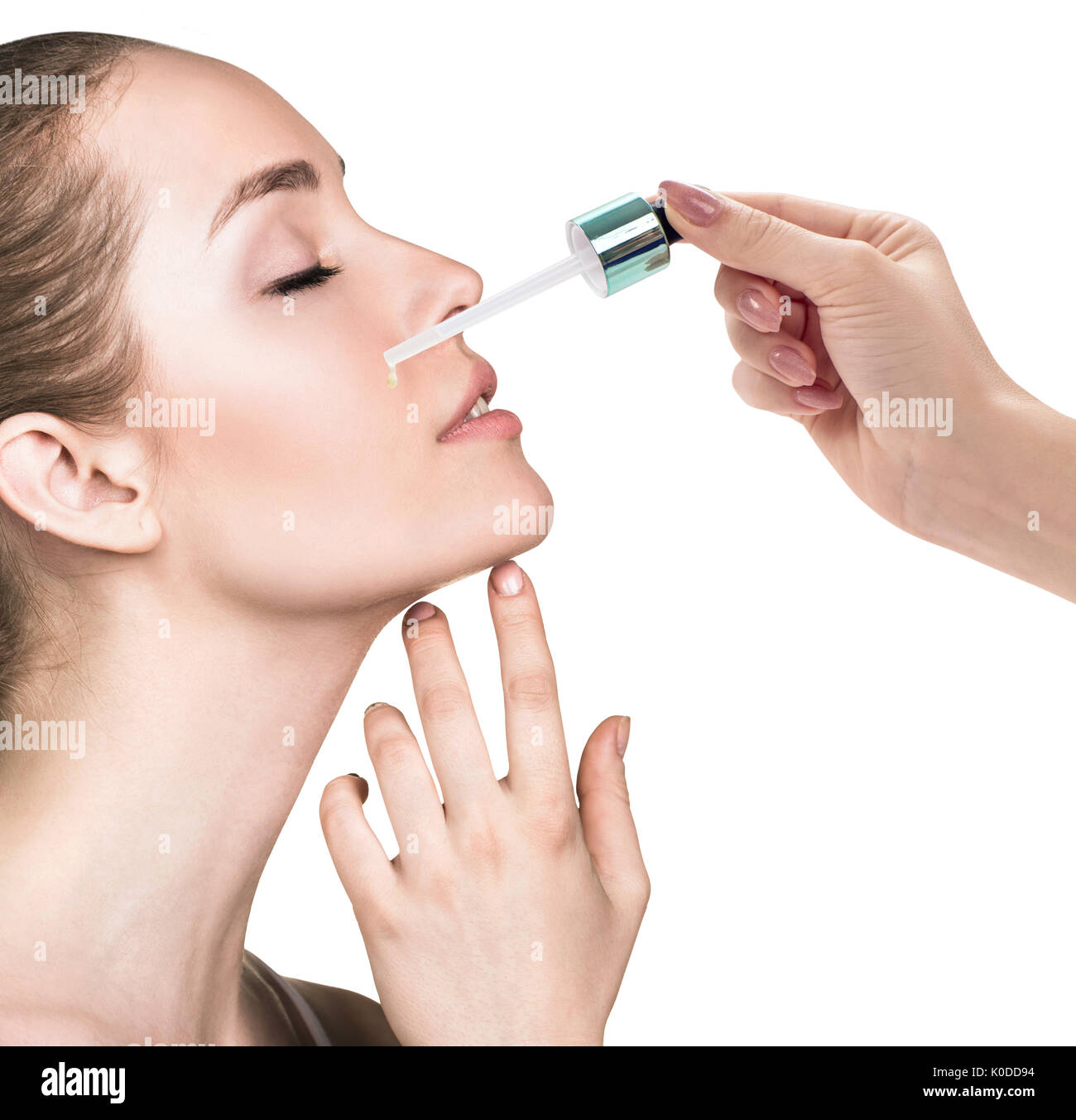 Cosmetic oil applying on face of young woman Stock Photo - Alamy