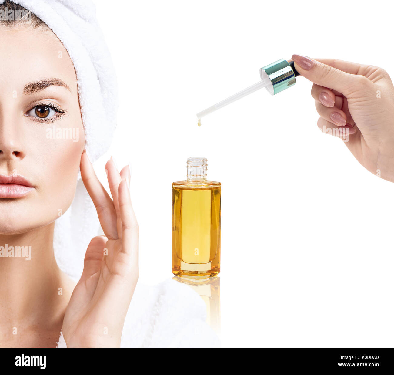 Cosmetic oil applying on face of young woman Stock Photo - Alamy