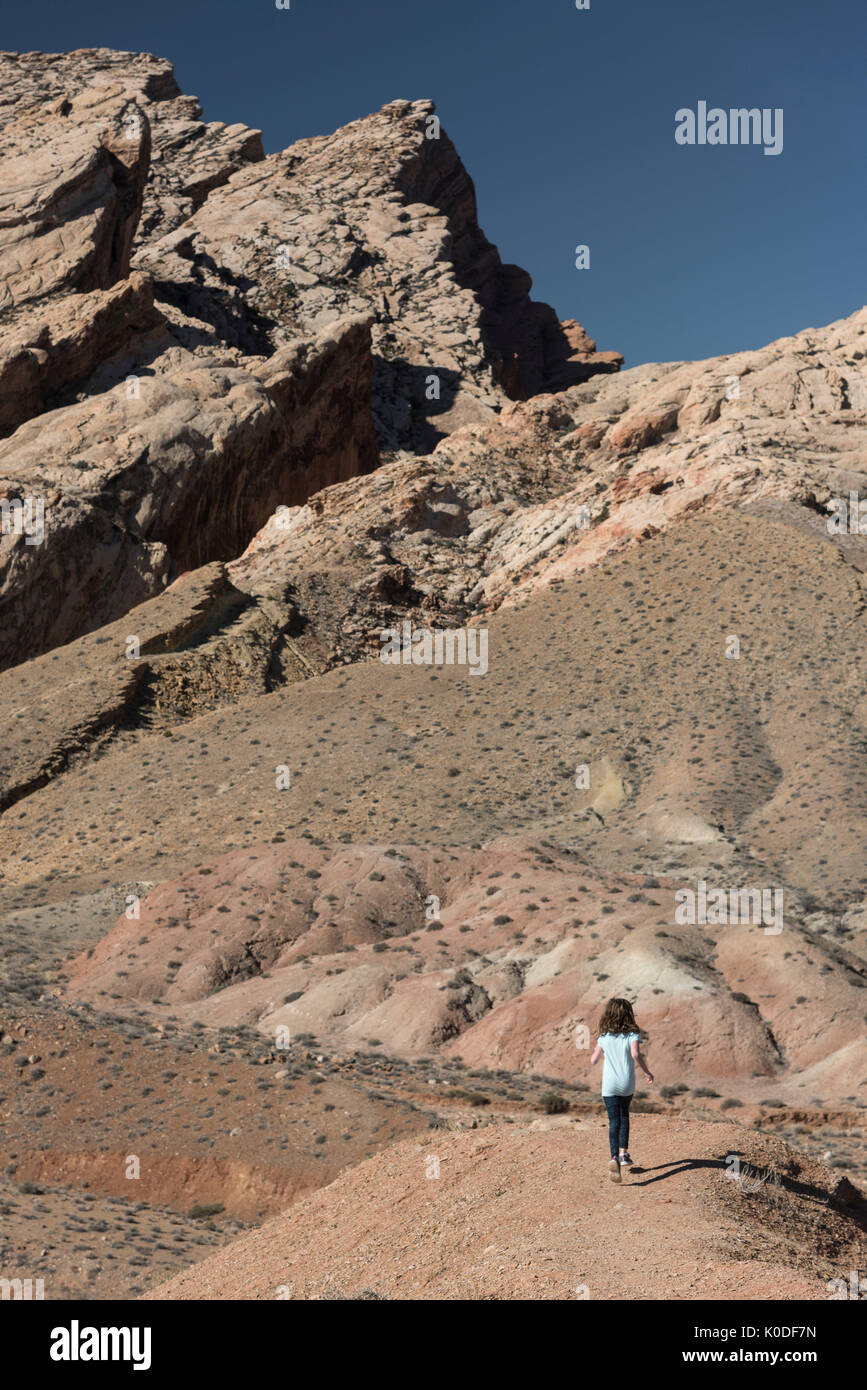 USA, Utah, San Rafael Reef, girl running at rest area with cliffs in ...