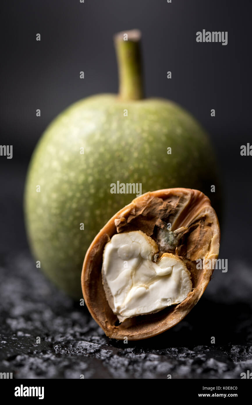 A fresh green walnut in the peel is fresh from the tree. Walnut on a ...