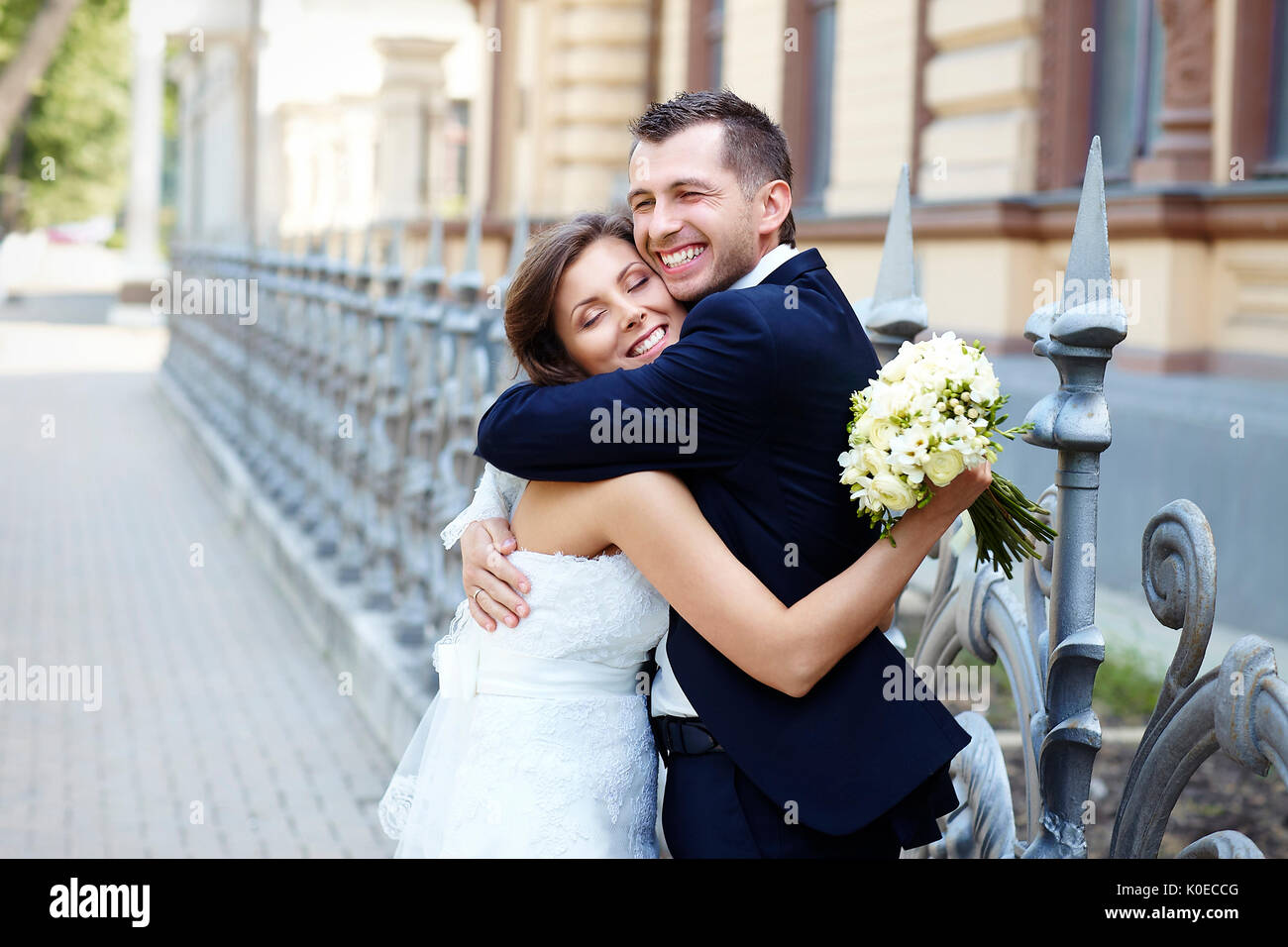 Happy bride and groom laughing smiling hugging on wedding day Stock ...