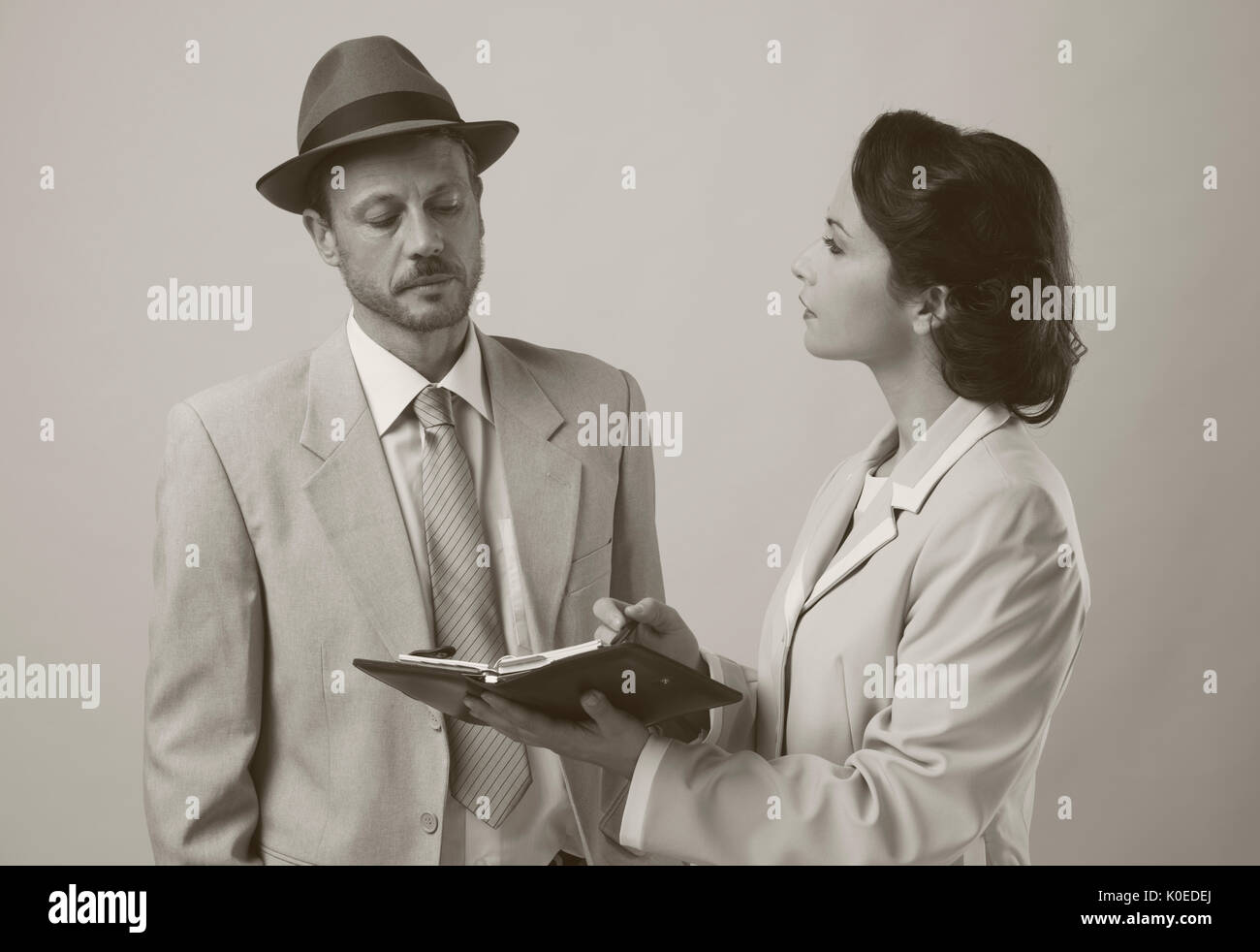 Vintage manager and secretary working together checking notes and ...