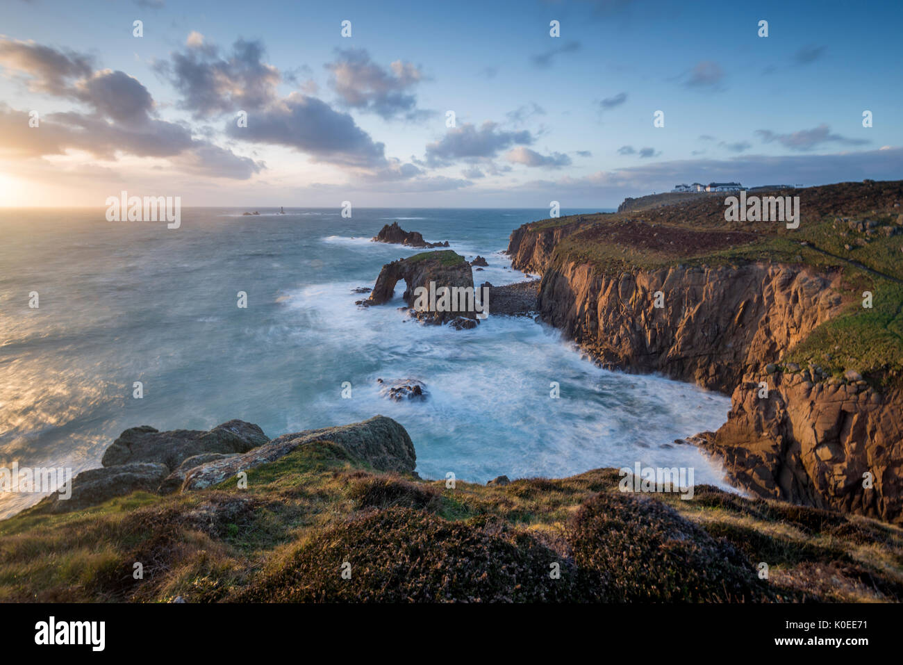 The view towards the rock arch Enys Dodnan at Land's End Stock Photo ...
