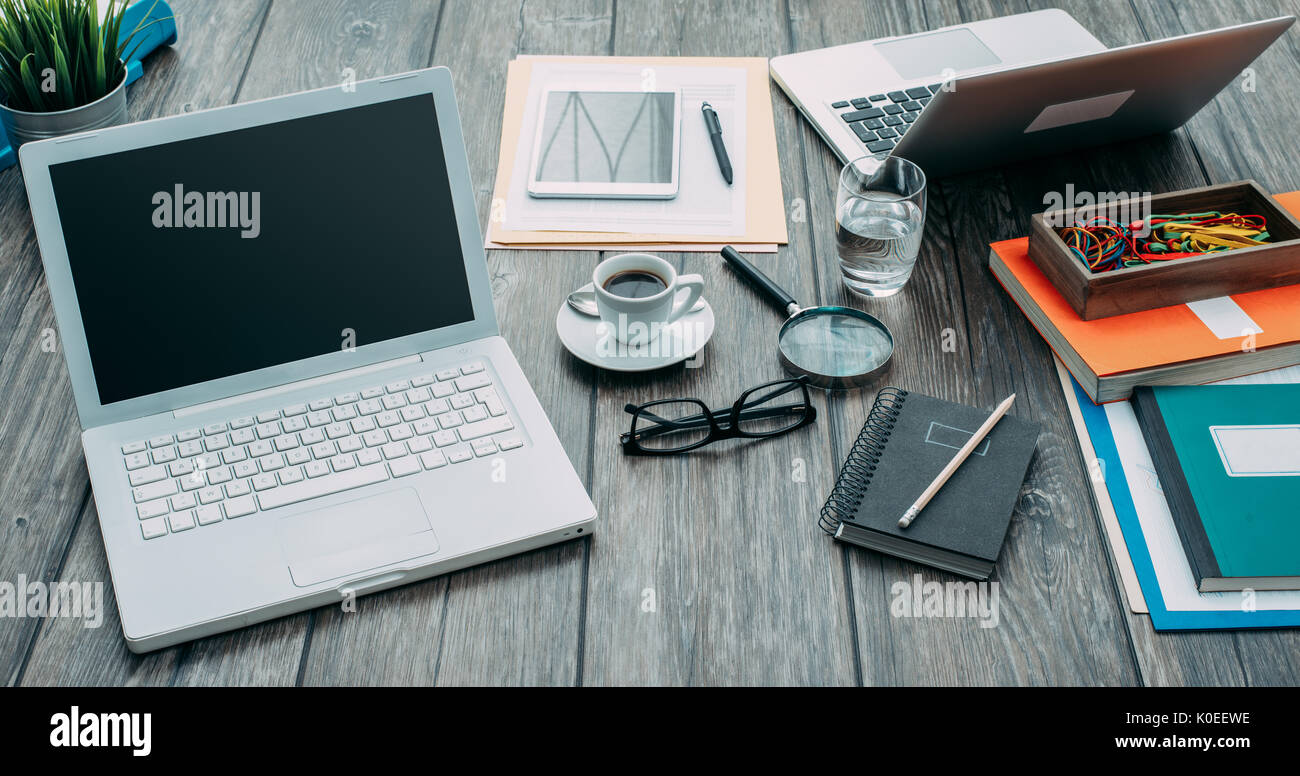 Business desktop in the office with two laptops and paperwork Stock ...