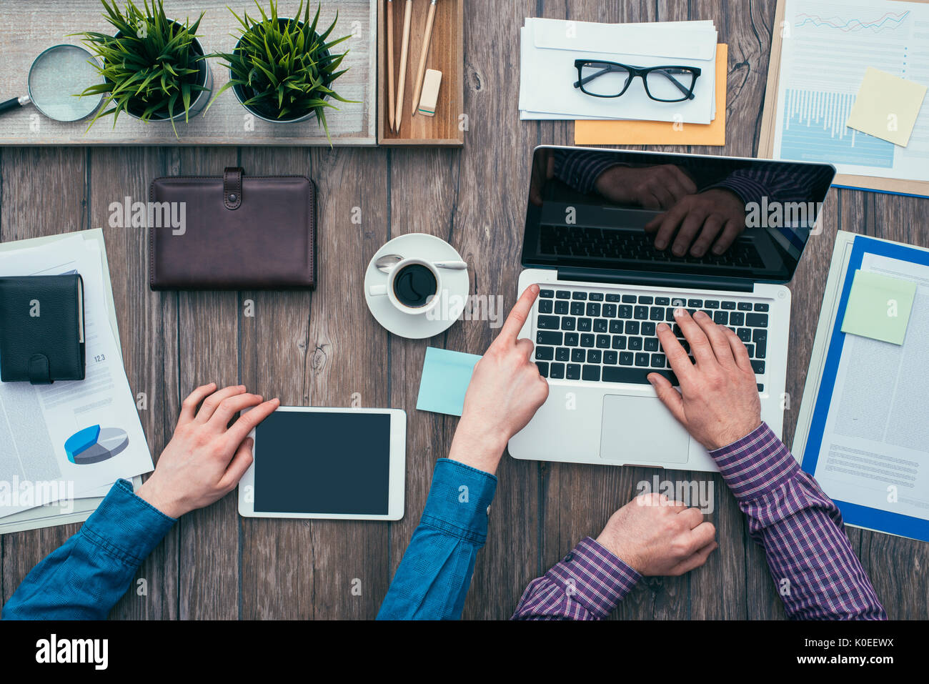 Business partners working together at office desk, they are using a ...