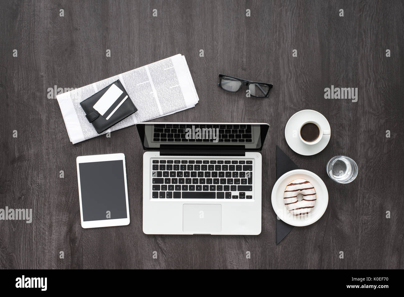 Coffee break in a corporate business office: laptop, espresso and donut ...