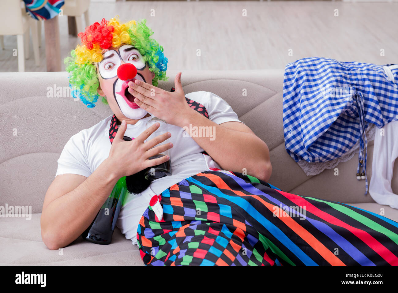 Drunk clown celebrating having a party at home Stock Photo - Alamy