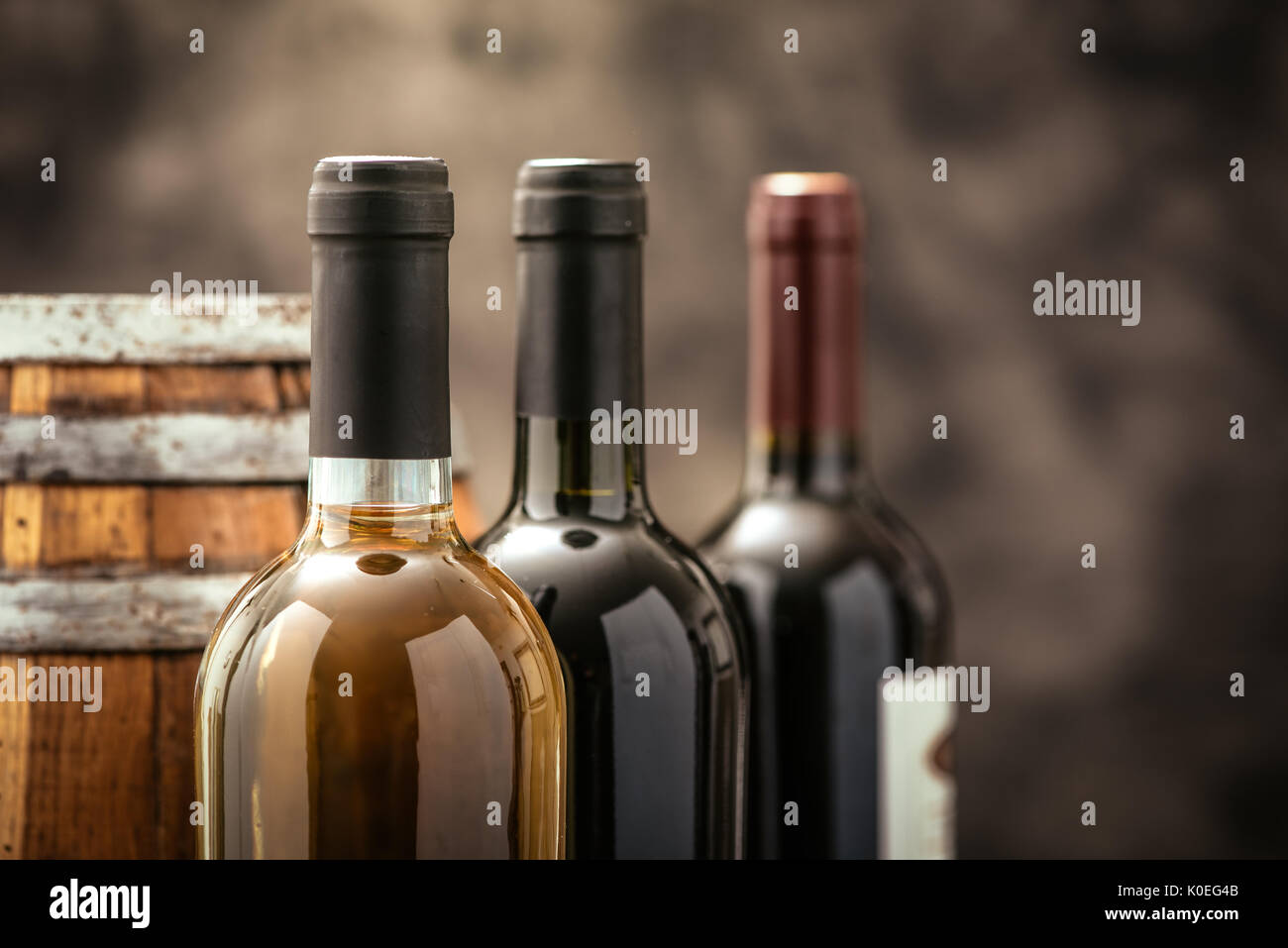 Expensive wine bottles collection and wooden barrel in the cellar, wine ...