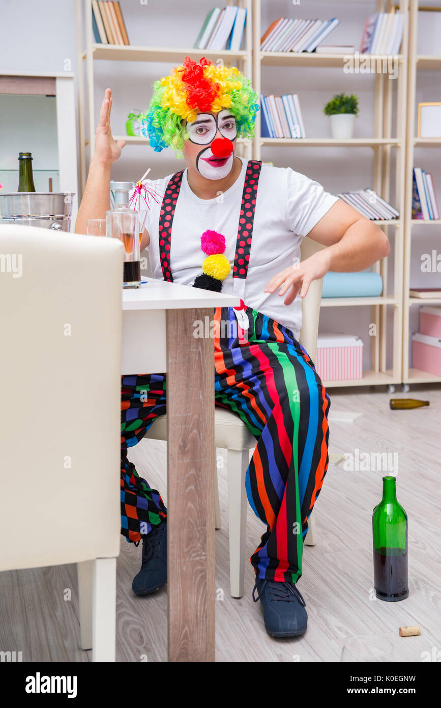 Drunk clown celebrating having a party at home Stock Photo - Alamy