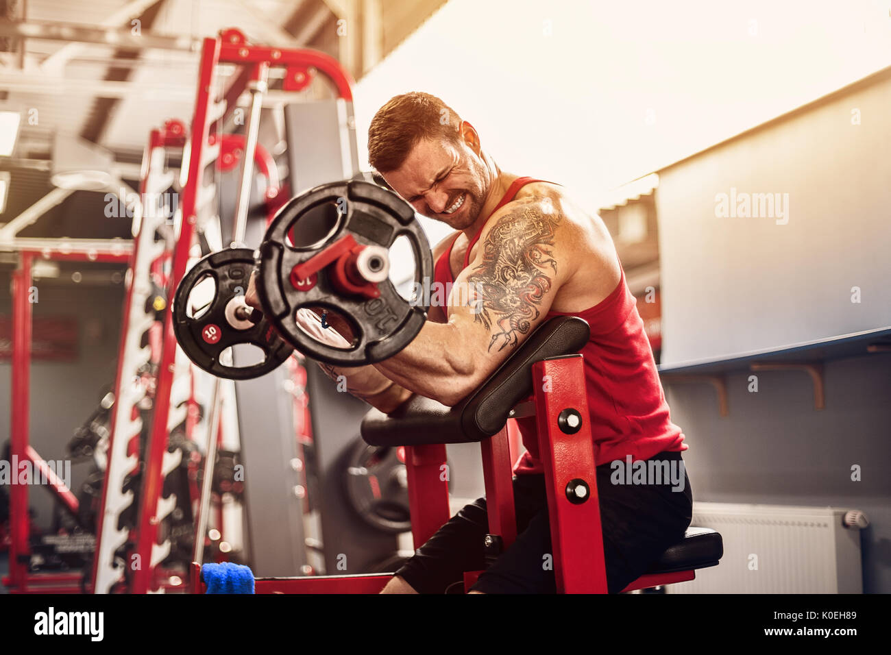 Man bodybuilder doing the set of a barbell exercise in a gym. Real time ...