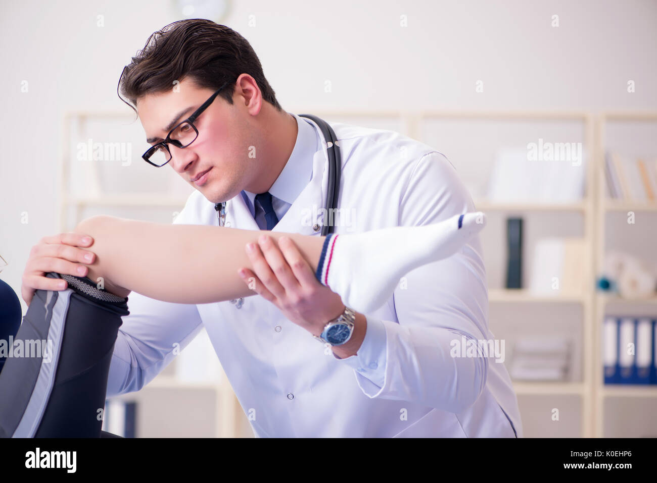 Man doctor taking care of sports injury Stock Photo - Alamy