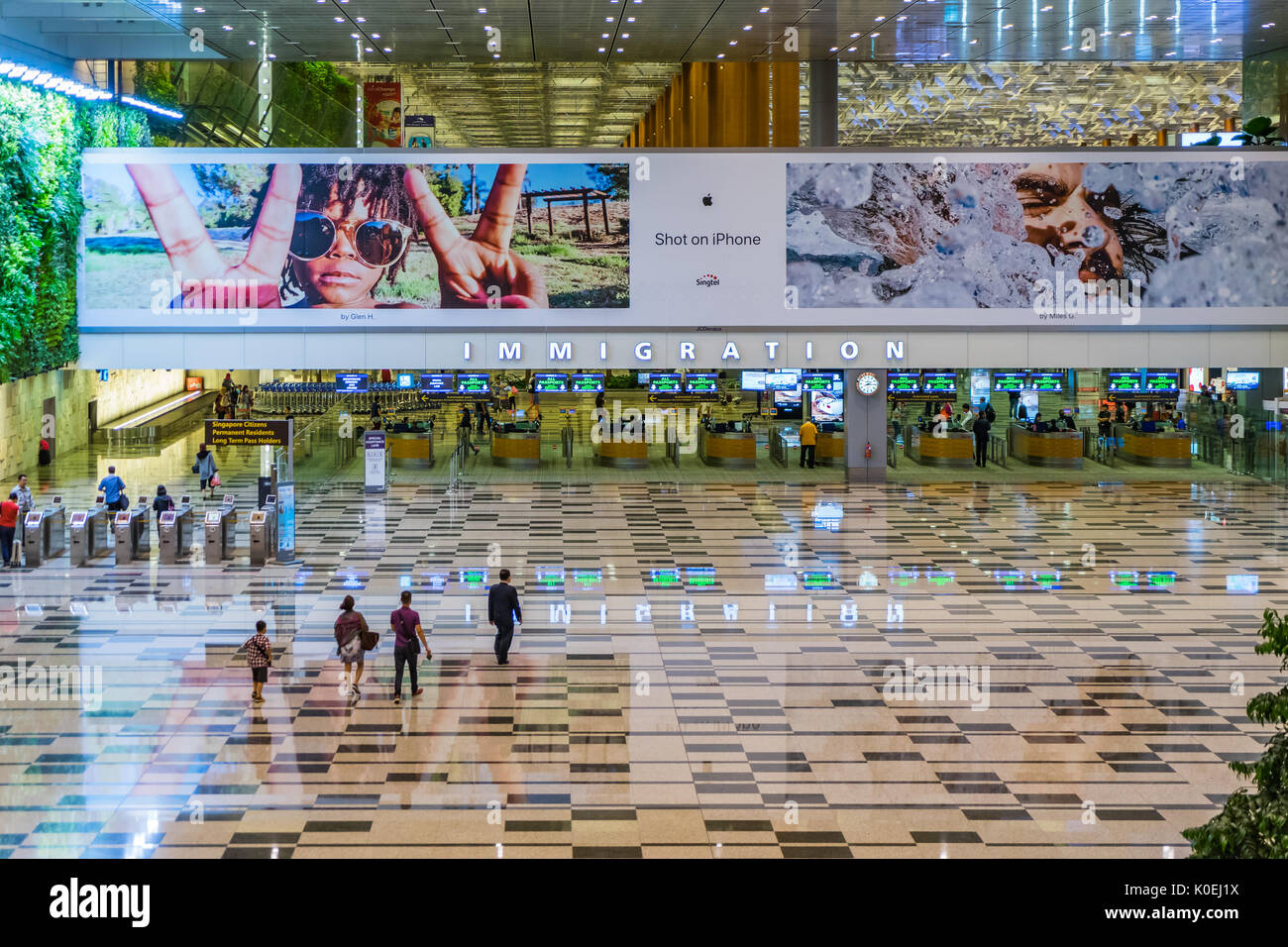 Singapore - July 16, 2017: Visitors walk around Arrival Hall ...