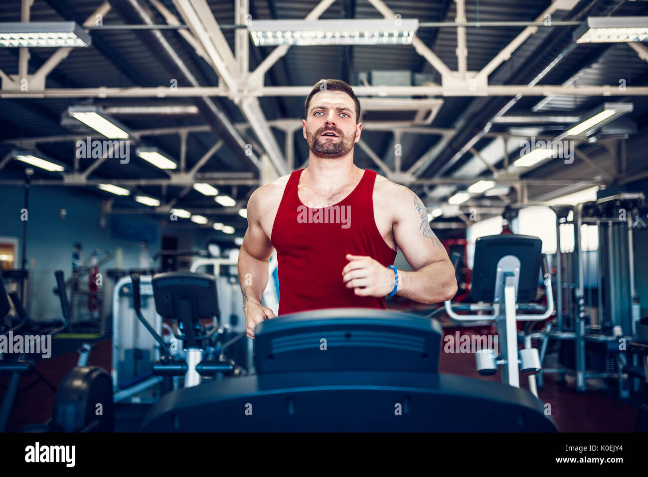 Muscle man running on treadmill Stock Photo - Alamy