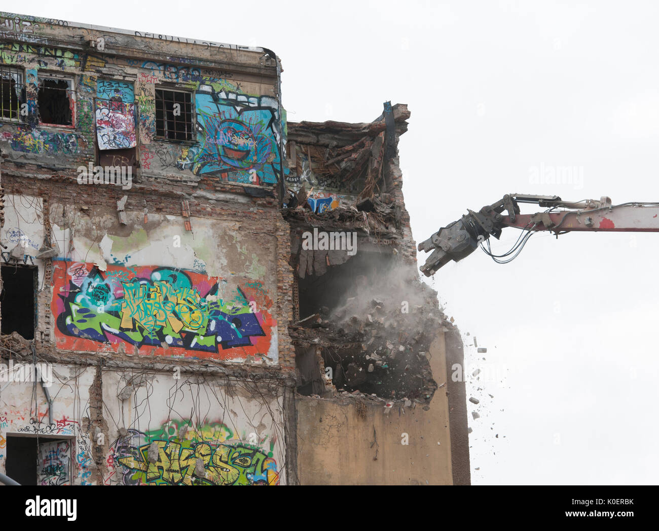A mechanical claw is used to tear down the former headquarters of the ...