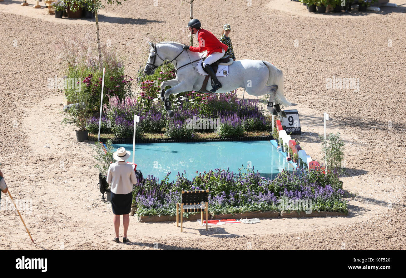 German show jumper Philipp Weishaupt on his horse LB Convall going over ...
