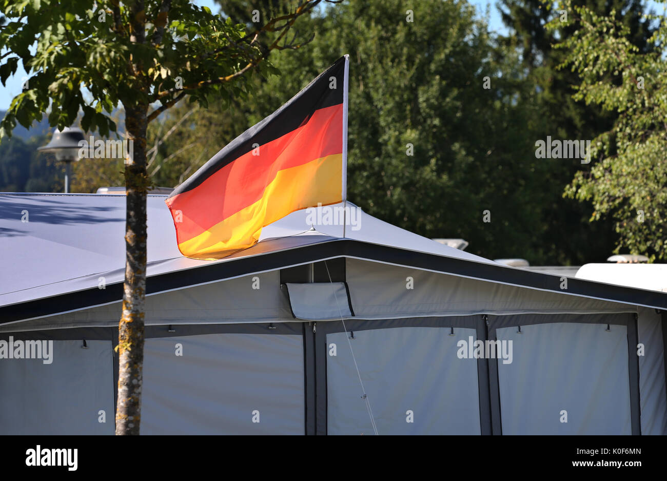 A German flag on a tent at a camping site at Forggensee lake near ...