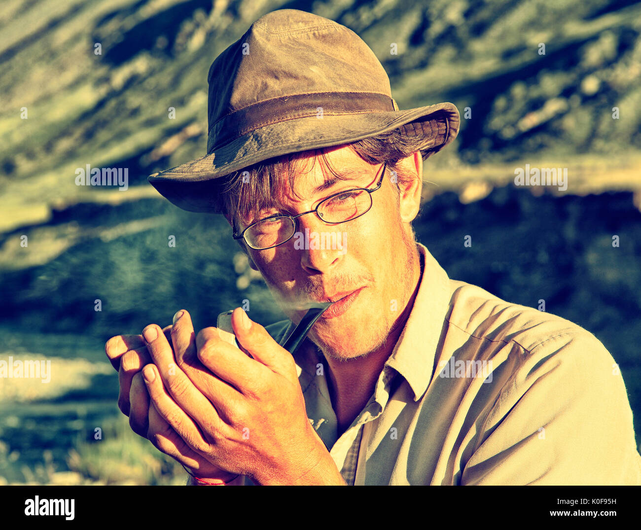 Colorized vintage outdoor portrait of tourist smoking tobacco-pipe near ...