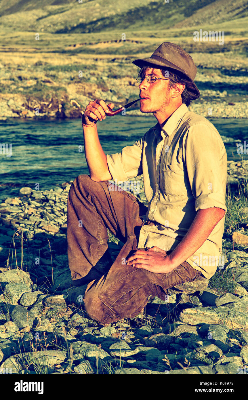 Colorized vintage outdoor portrait of tourist smoking tobacco-pipe near ...