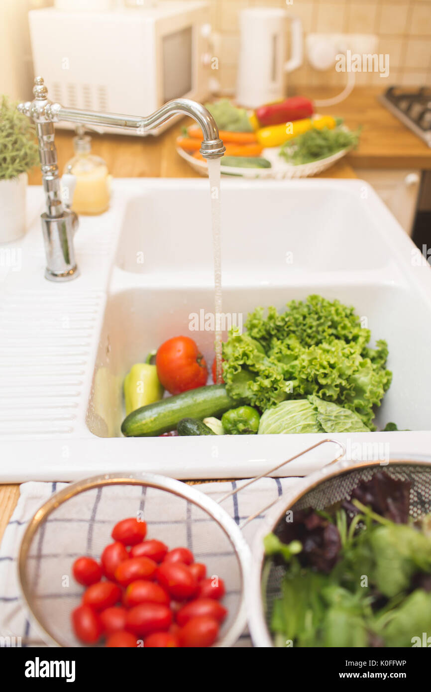 Lots of fresh vegetables in sink for salad preparing Stock Photo - Alamy