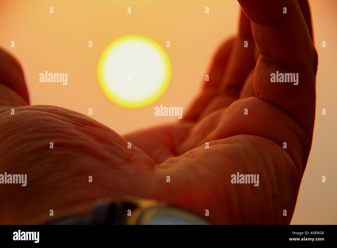 Silhouette someone holding the sun in their hand, Show that they can do ...