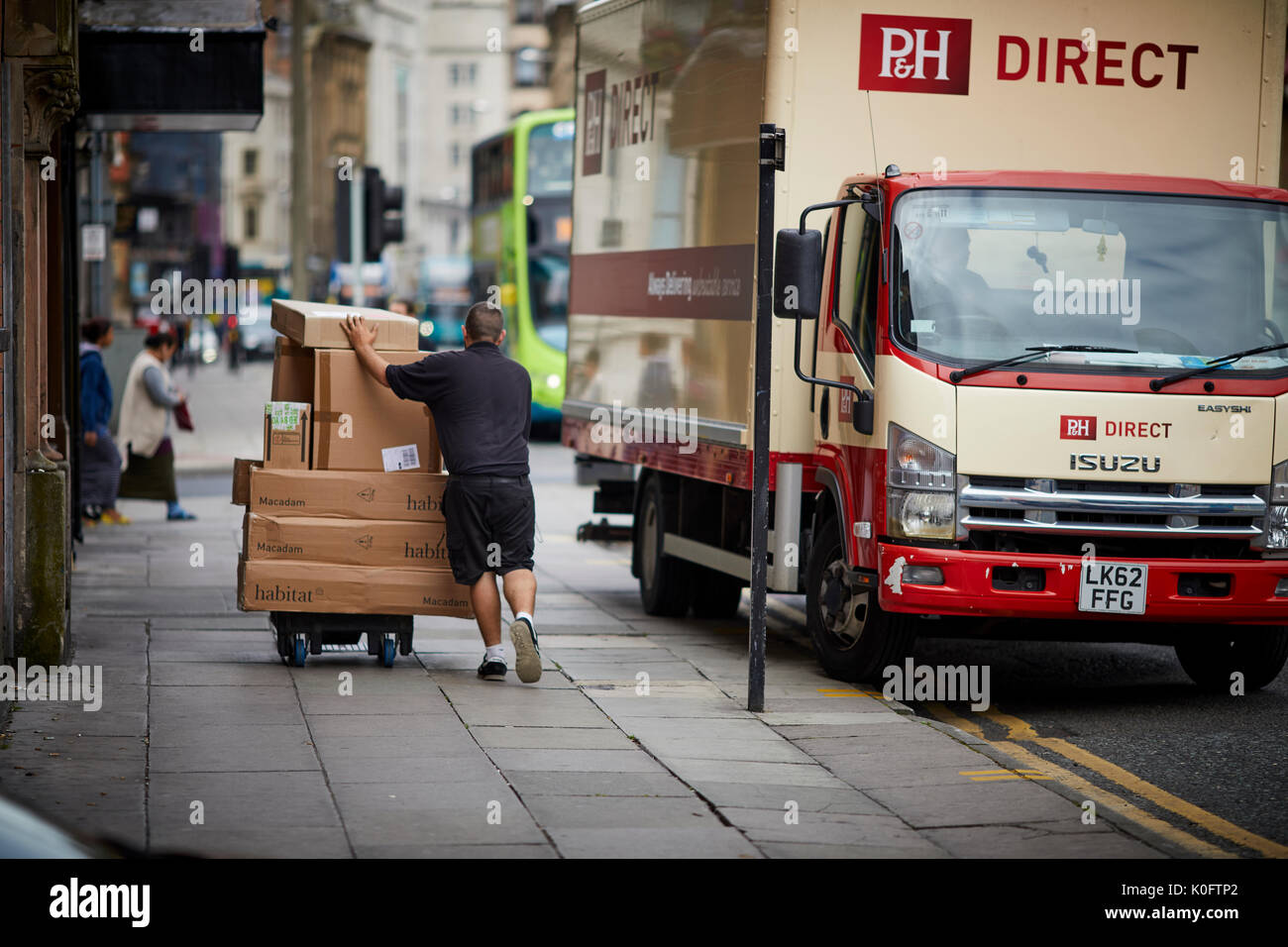 A delivery van parks no the pavement and double yellow line as a ...