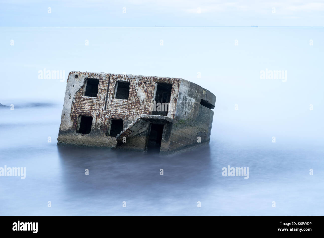 Liepaja beach bunker. Brick house, soft water, waves and rocks ...