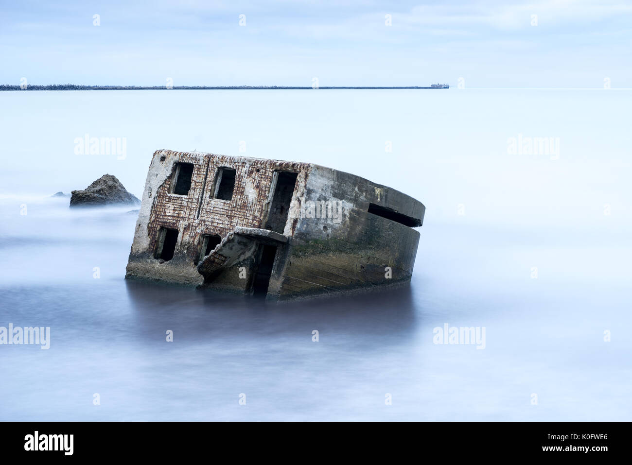 Liepaja beach bunker. Brick house, soft water, waves and rocks ...