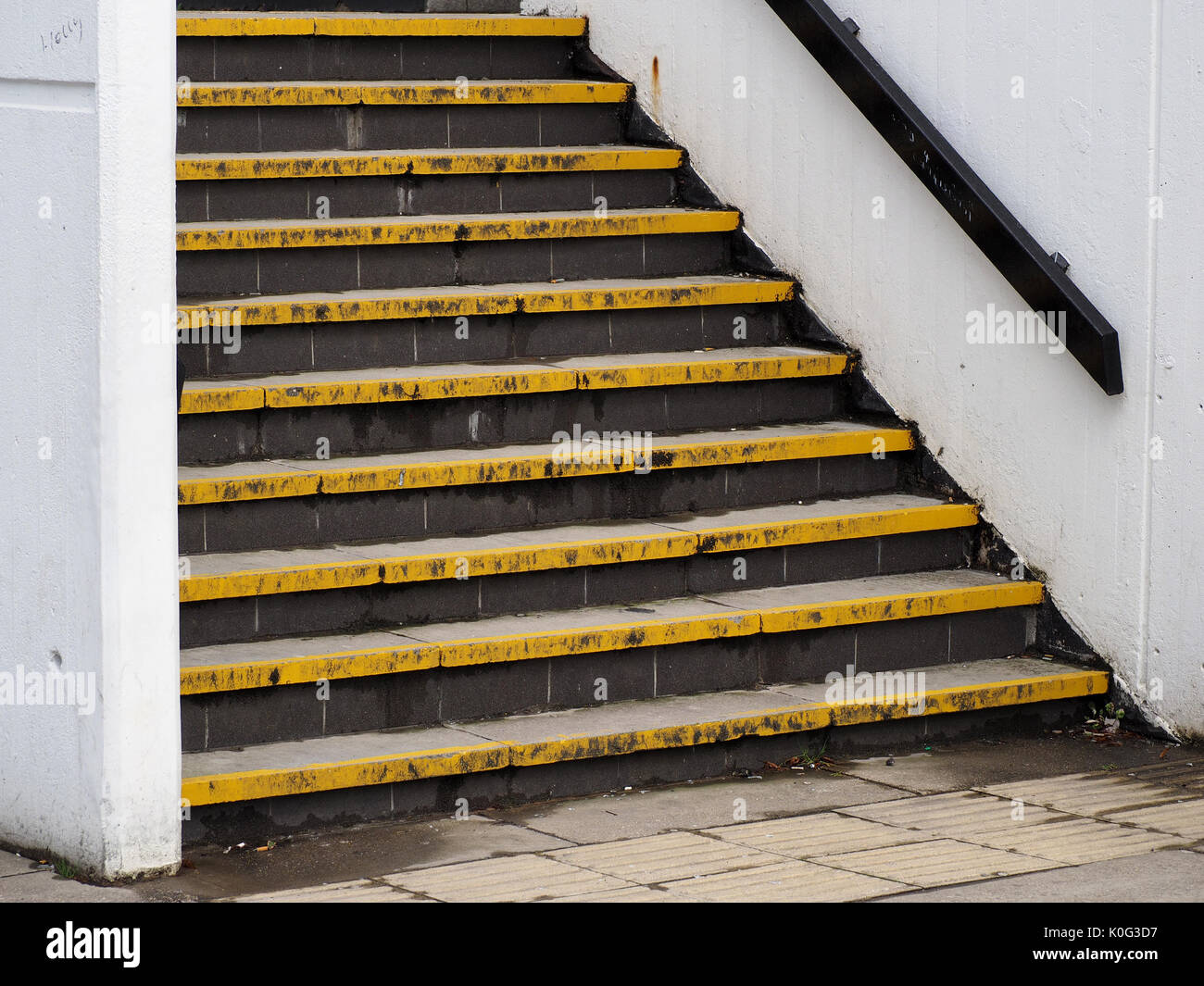 open-air staircase with yellow edged treads and risers and black ...