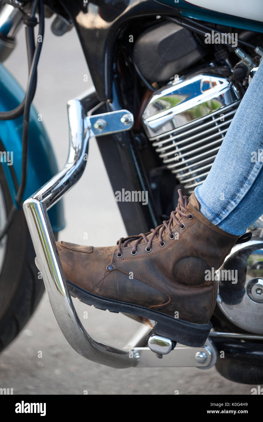 Motorcycle boot on the footboard of a motorcycle, close-up Stock Photo ...