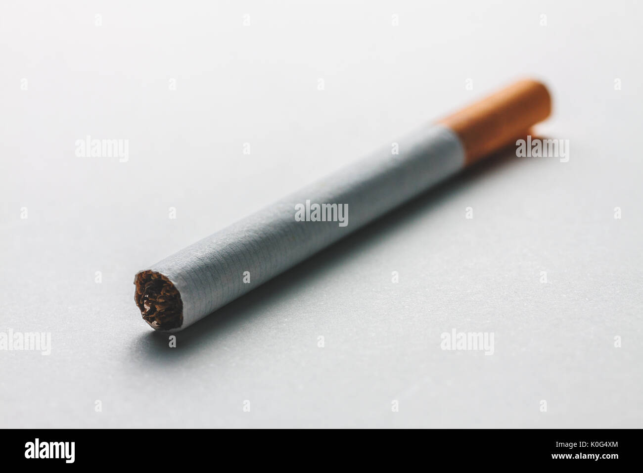 Close-up of a cigarette on a blank surface Stock Photo - Alamy