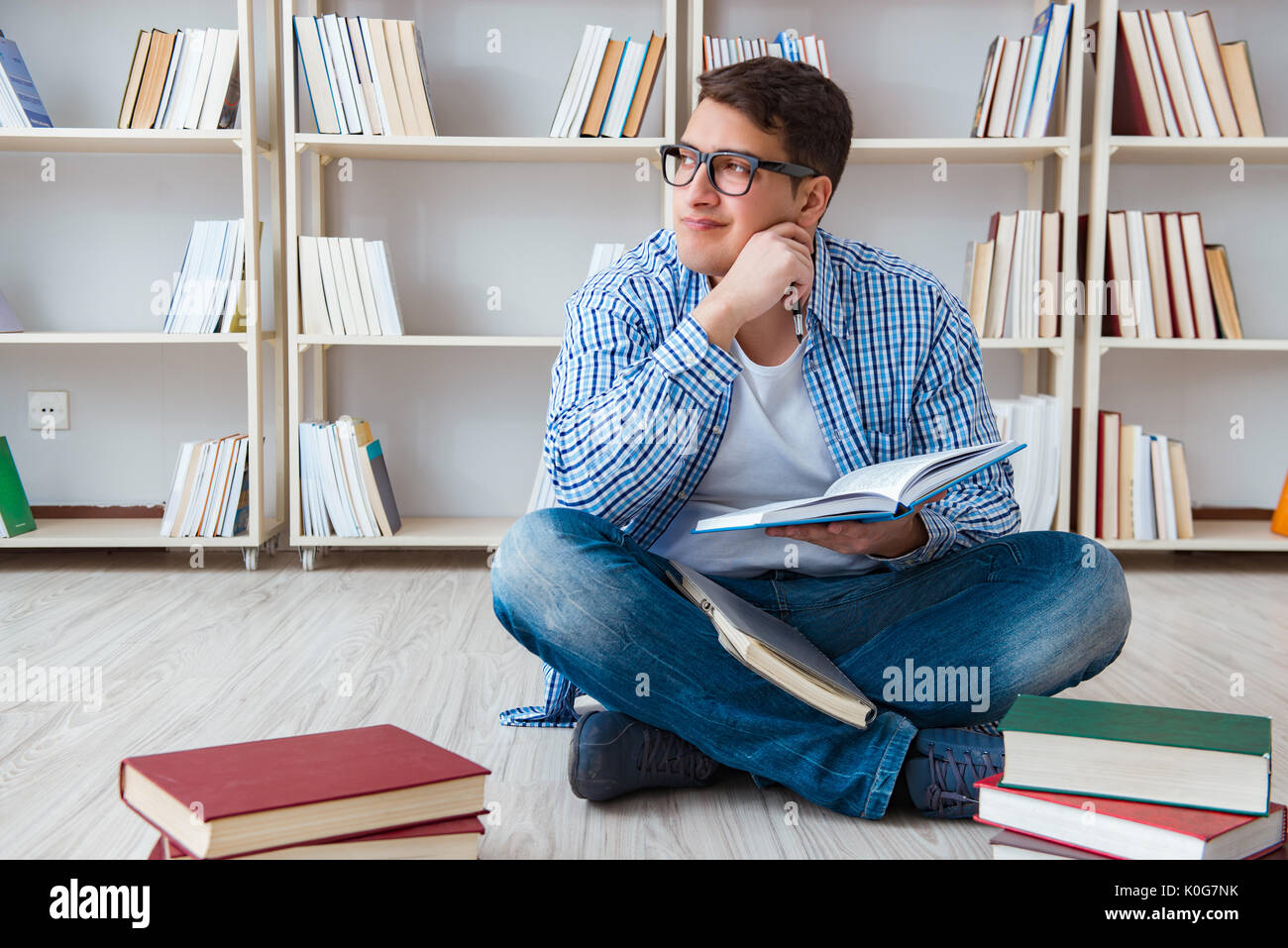 Young student studying with books Stock Photo - Alamy