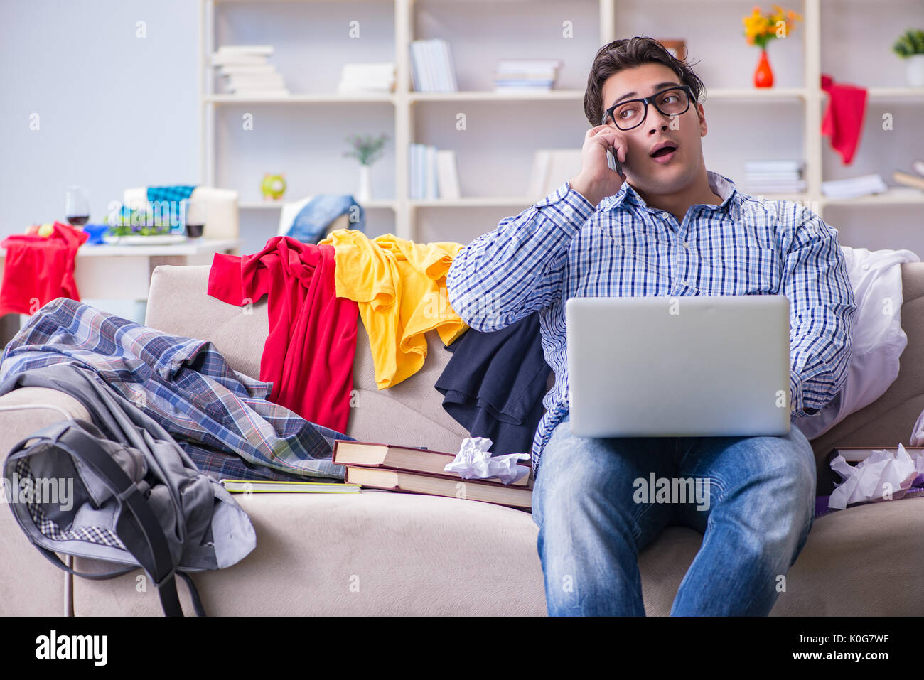Young man working studying in messy room Stock Photo - Alamy