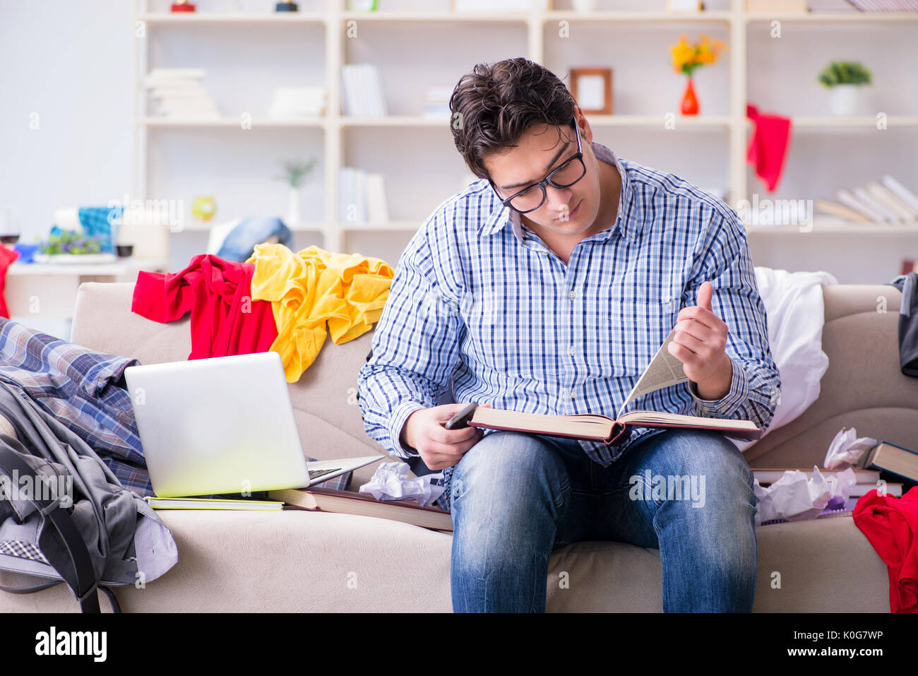 Young man working studying in messy room Stock Photo - Alamy