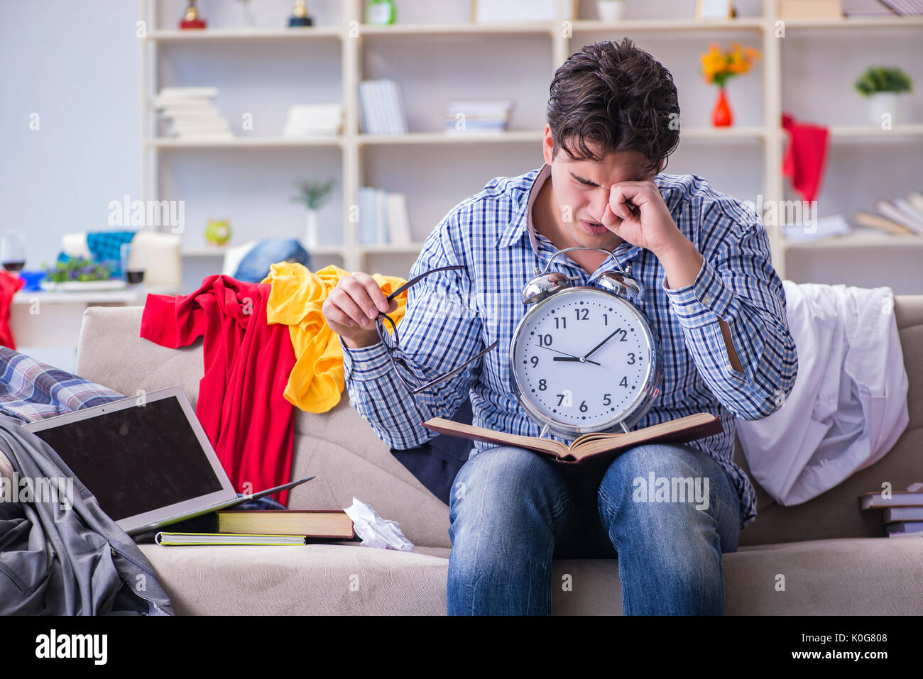 Young man working studying in messy room Stock Photo - Alamy