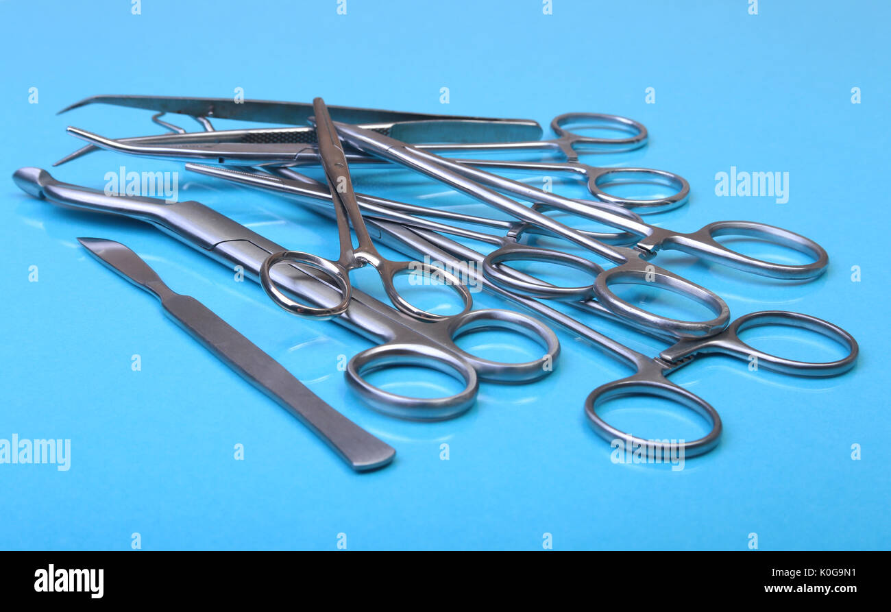 Close Up Surgical instruments and tools on blue mirror background ...