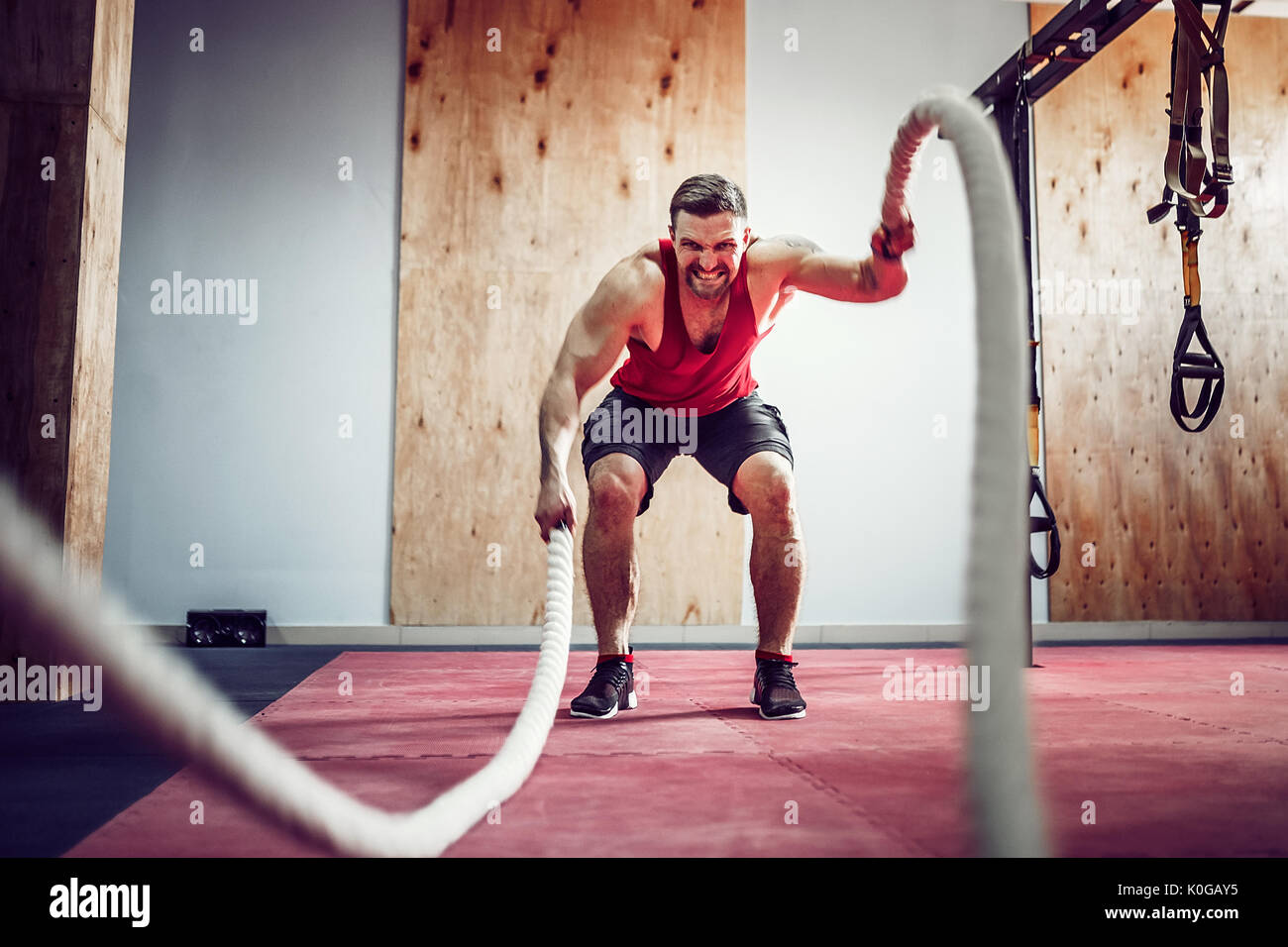 Men with rope in functional training fitness Stock Photo - Alamy
