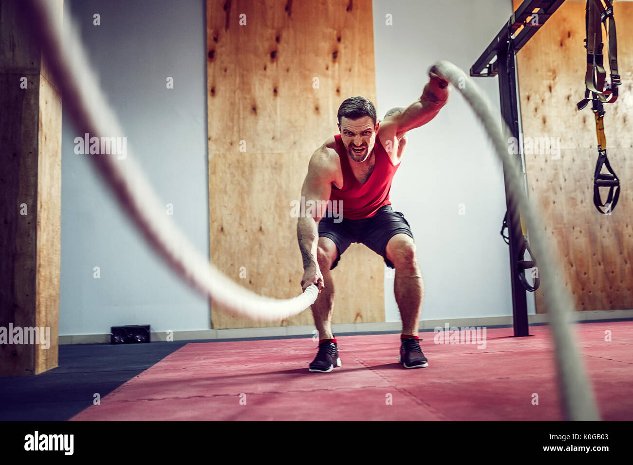 Men with rope in functional training fitness Stock Photo - Alamy