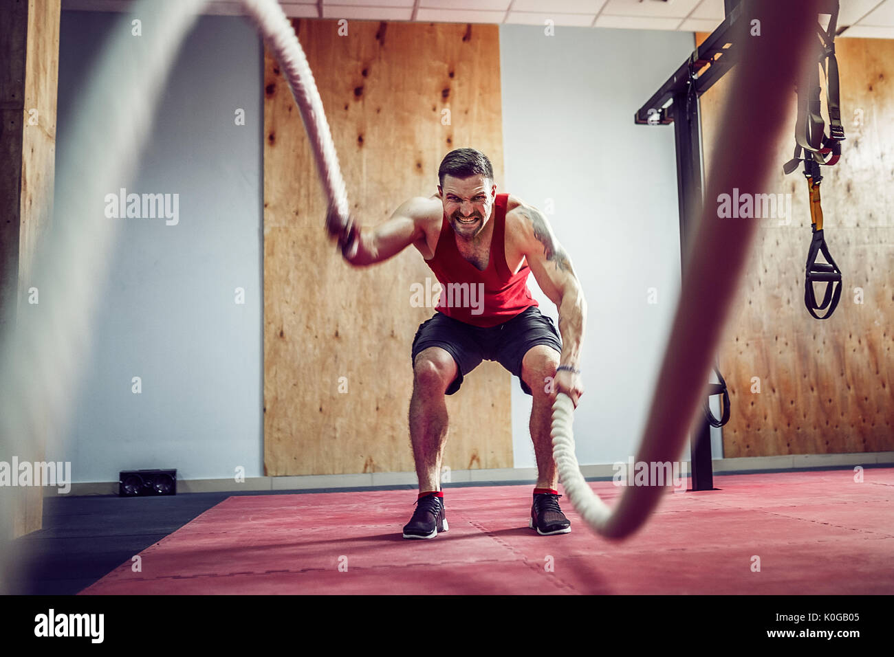 Men with rope in functional training fitness Stock Photo - Alamy