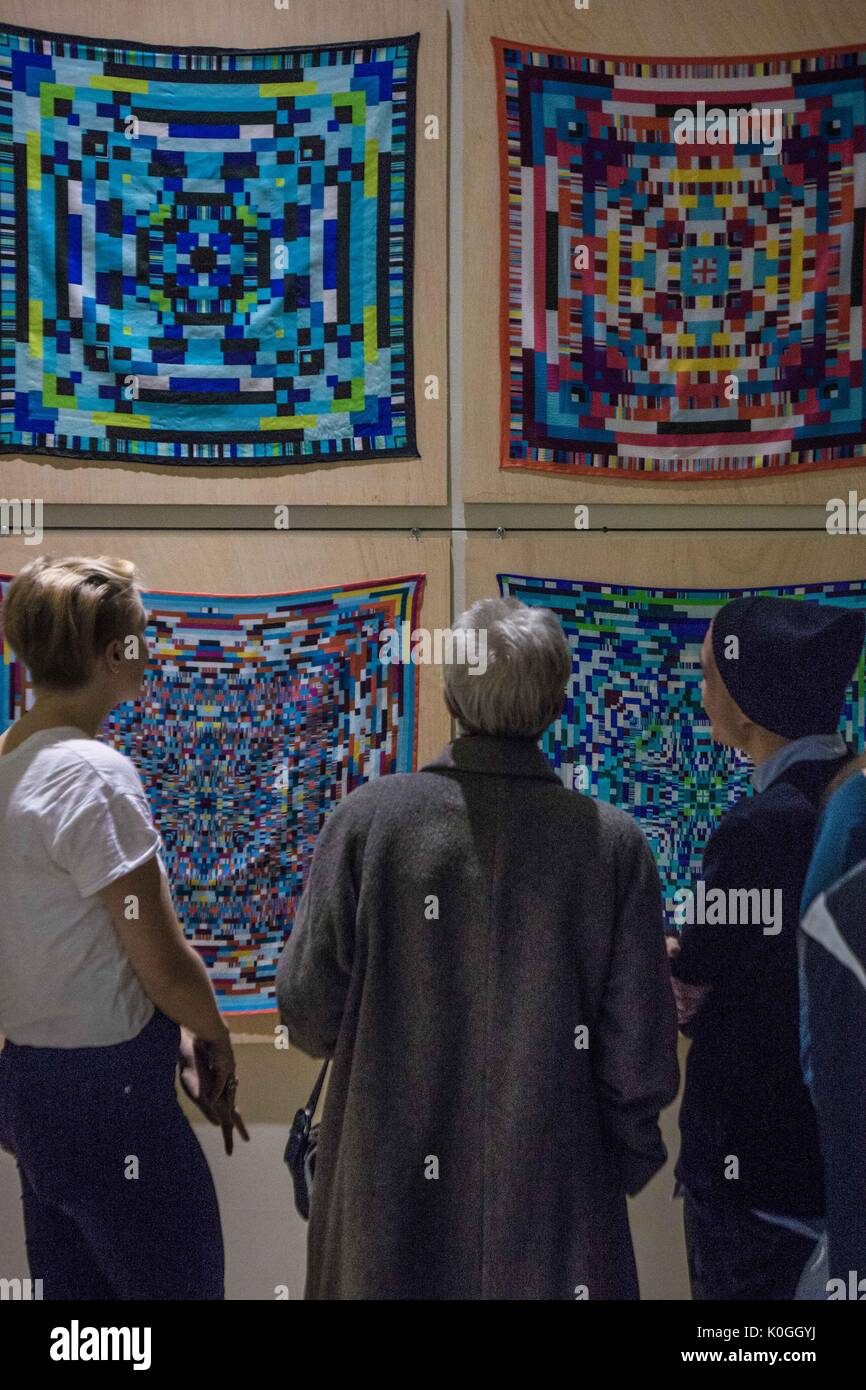 Looking at objects on display during the opening of art exhibition ...