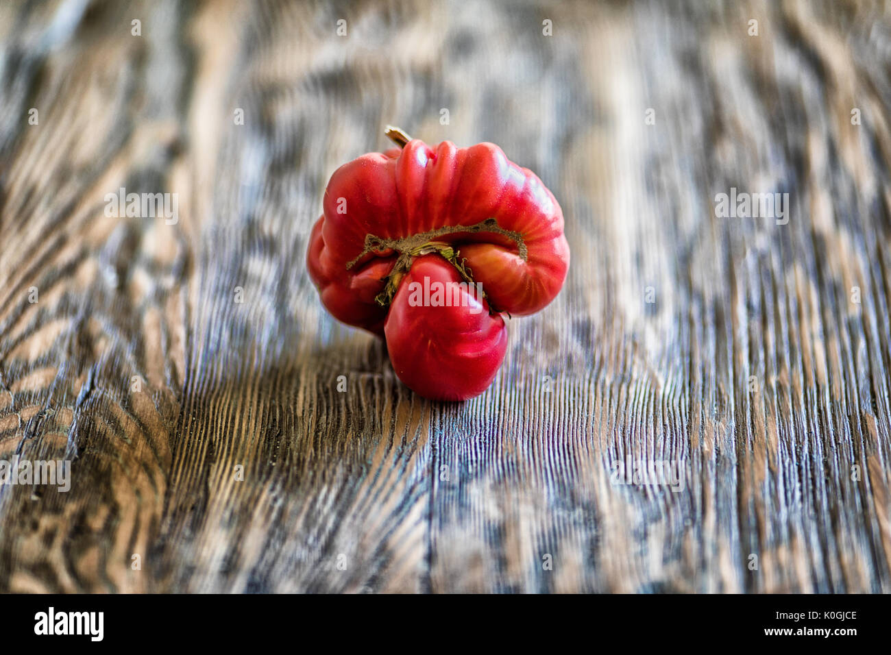Tomato like a human head on wooden background Stock Photo - Alamy