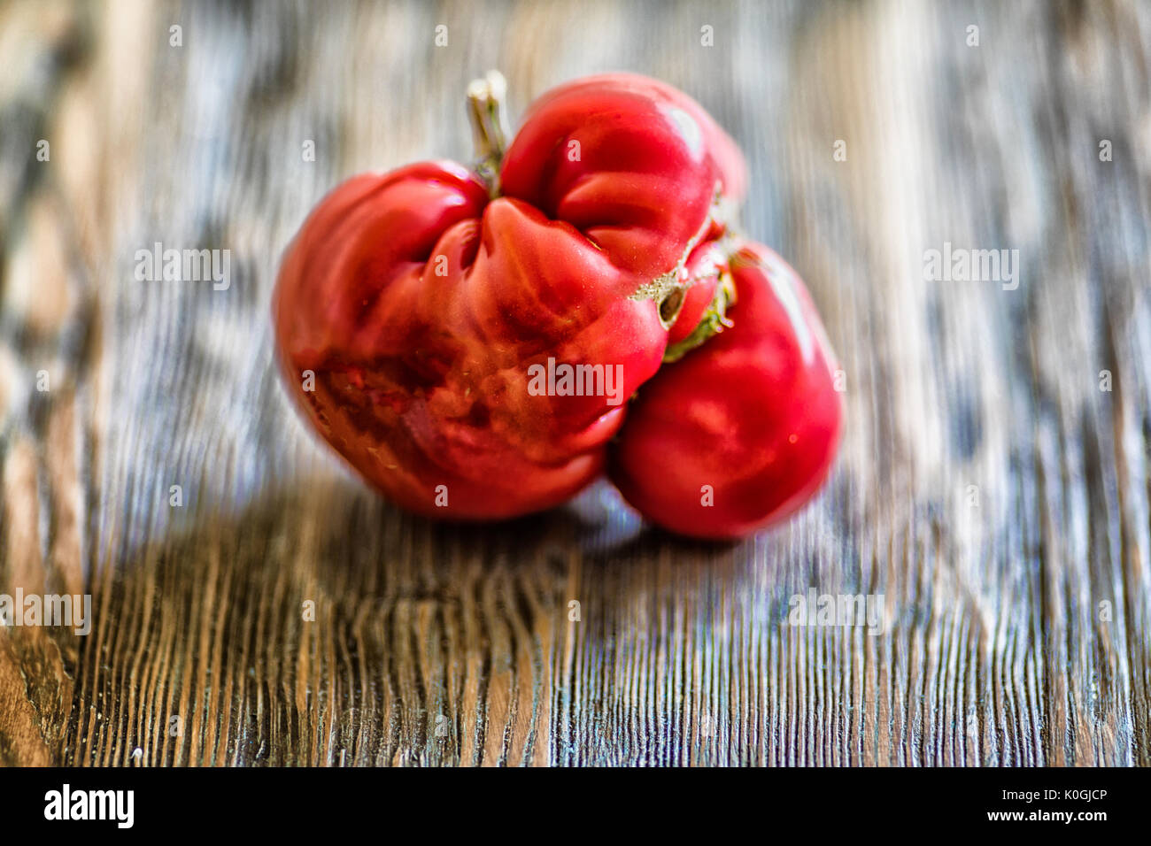 Tomato like a human head on wooden background Stock Photo - Alamy