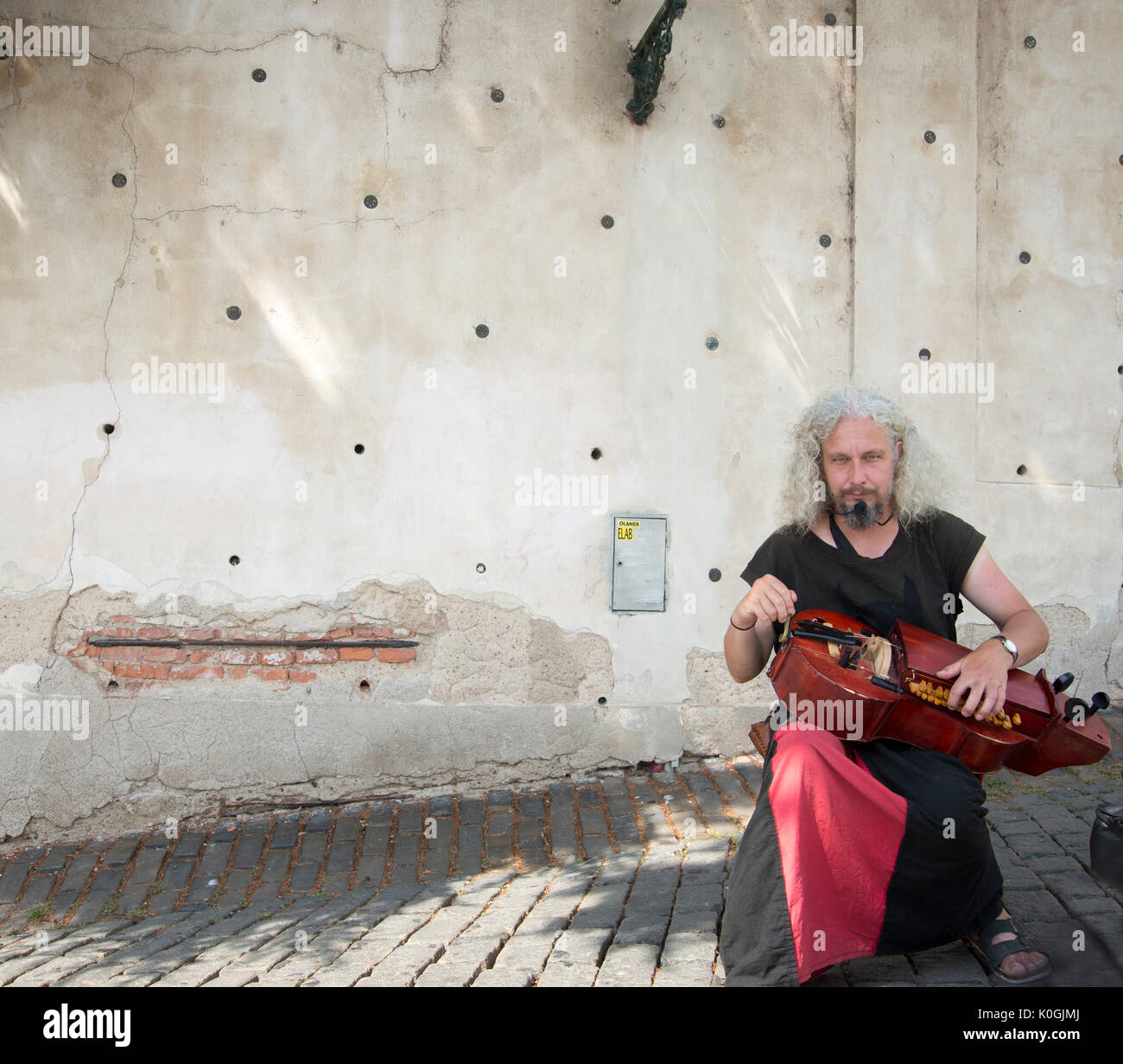 Street performer playing a traditional instrument in the district of ...