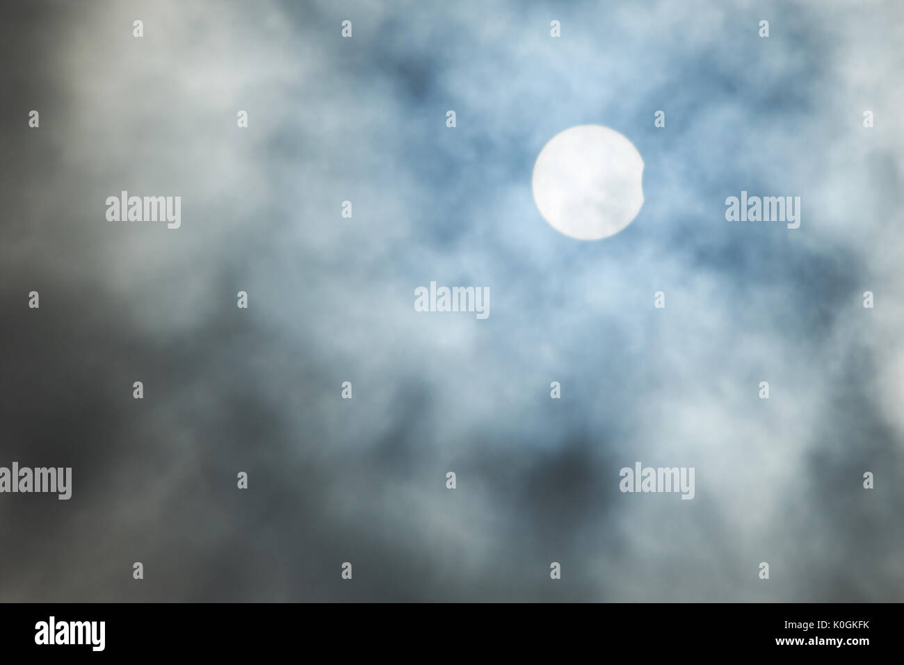 Real solar eclipse background on cloudy sky Stock Photo - Alamy