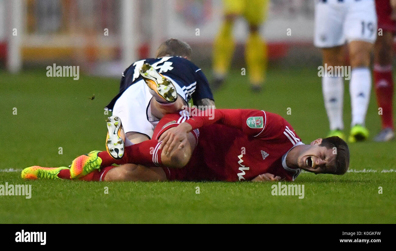 Accrington Stanley's Liam Nolan (right) reacts following a tackle by ...