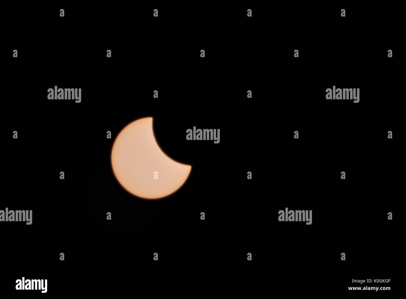 Partial solar eclipse isolated on black background Stock Photo - Alamy