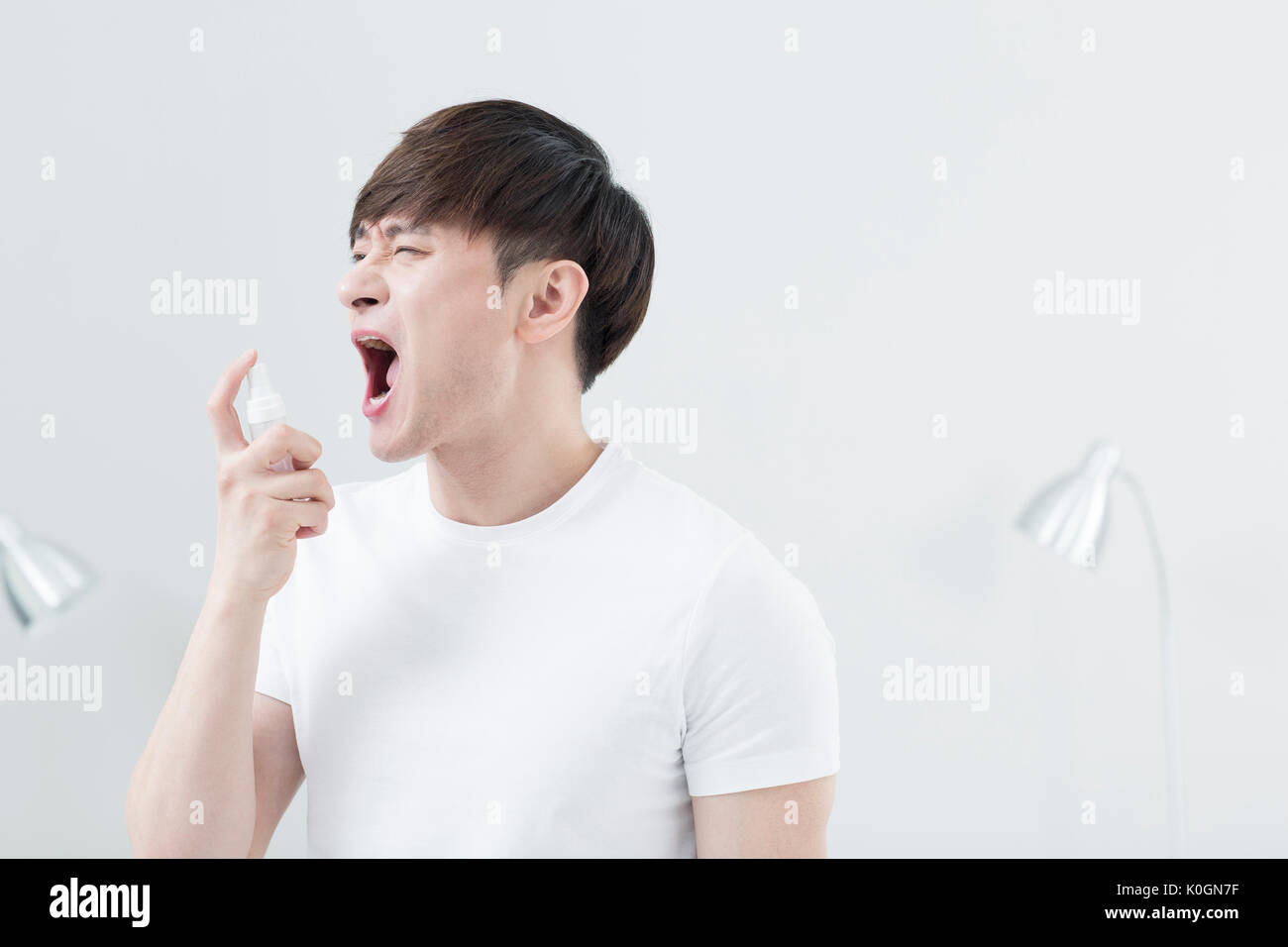 Man using mouth spray hi-res stock photography and images - Alamy