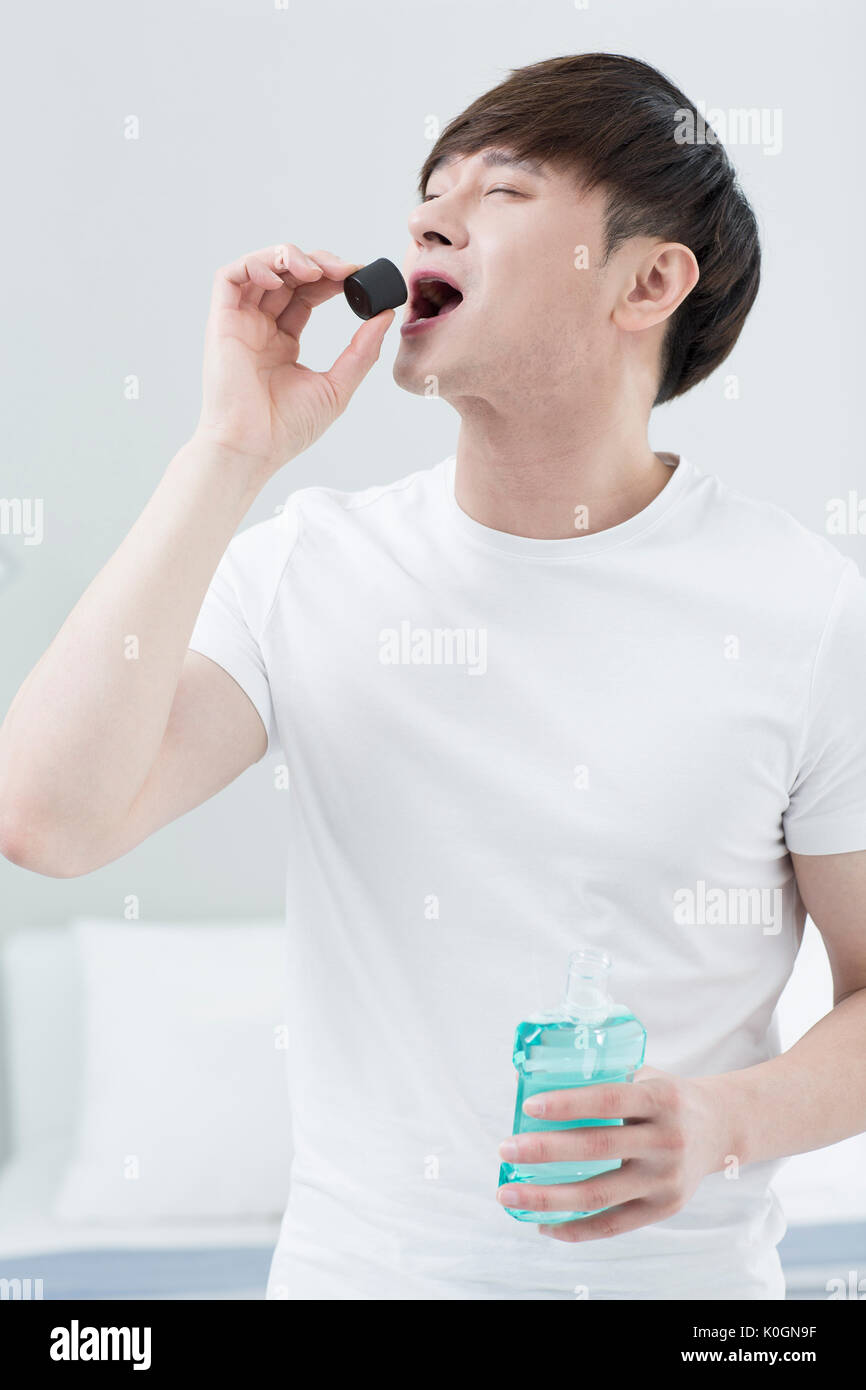 Portrait pf man using mouthwash Stock Photo - Alamy